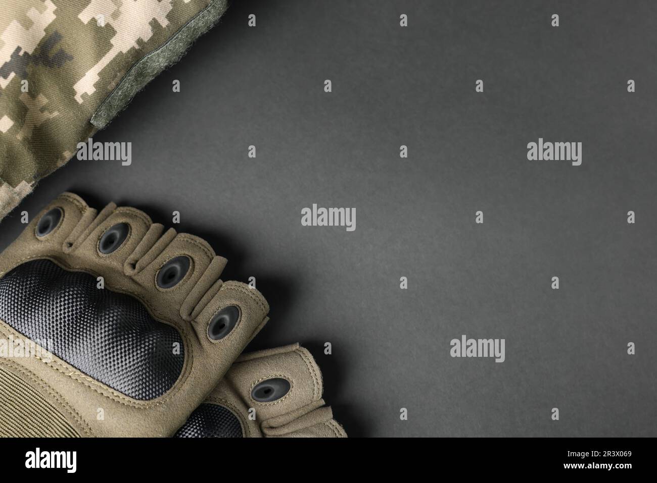 Tactical gloves and uniform on black background, flat lay with space ...