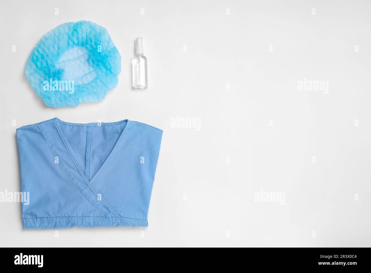 Medical uniform, cap and antiseptic on white background, flat lay ...