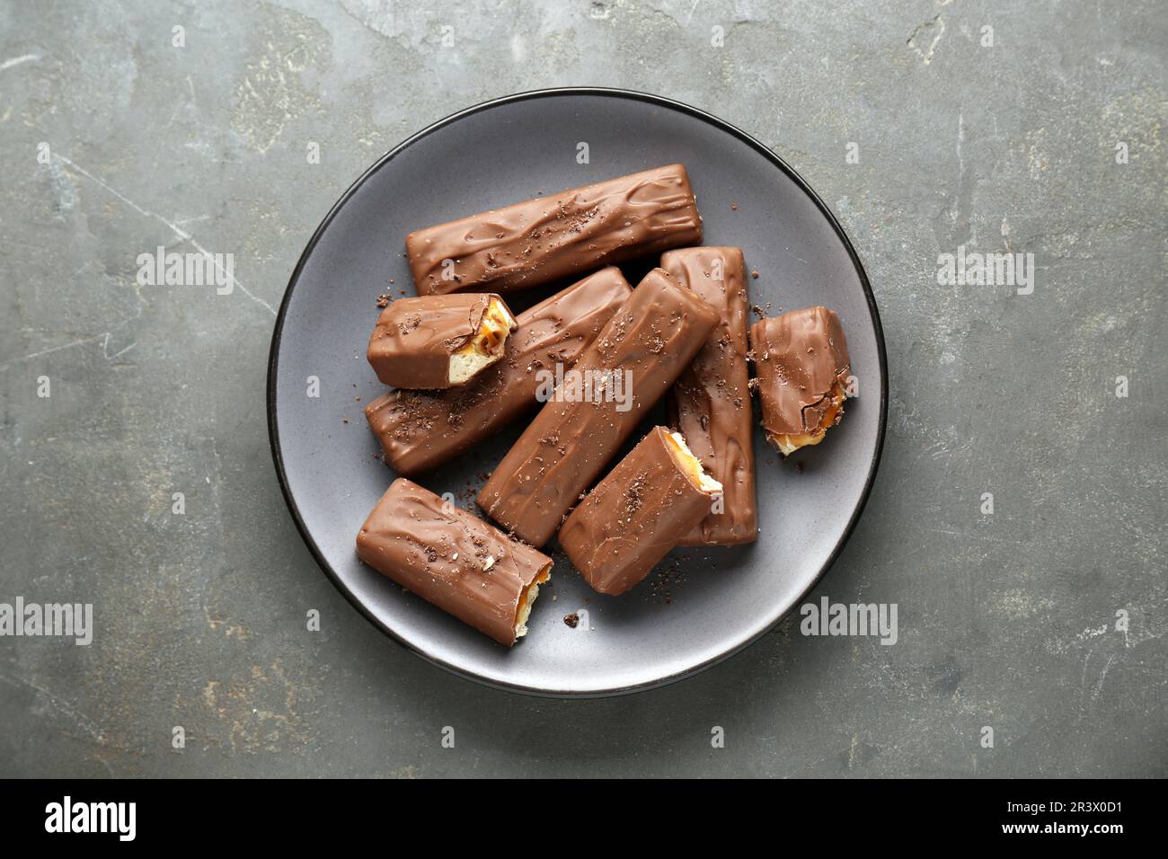 Tasty chocolate bars with caramel on grey table, top view Stock Photo ...