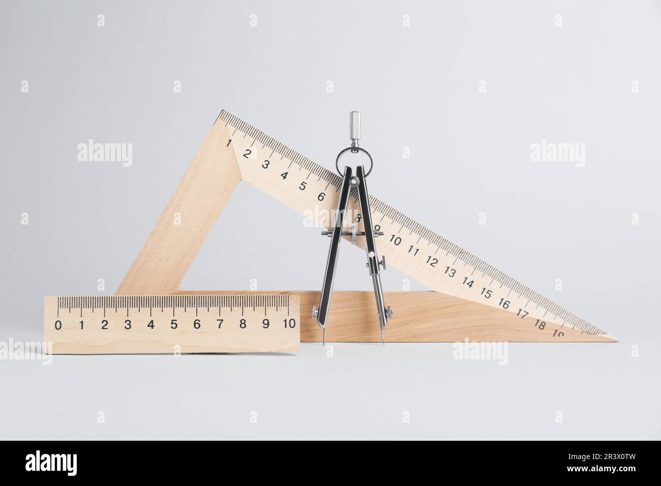 Ruler with measuring length markings, triangle and compass on white ...