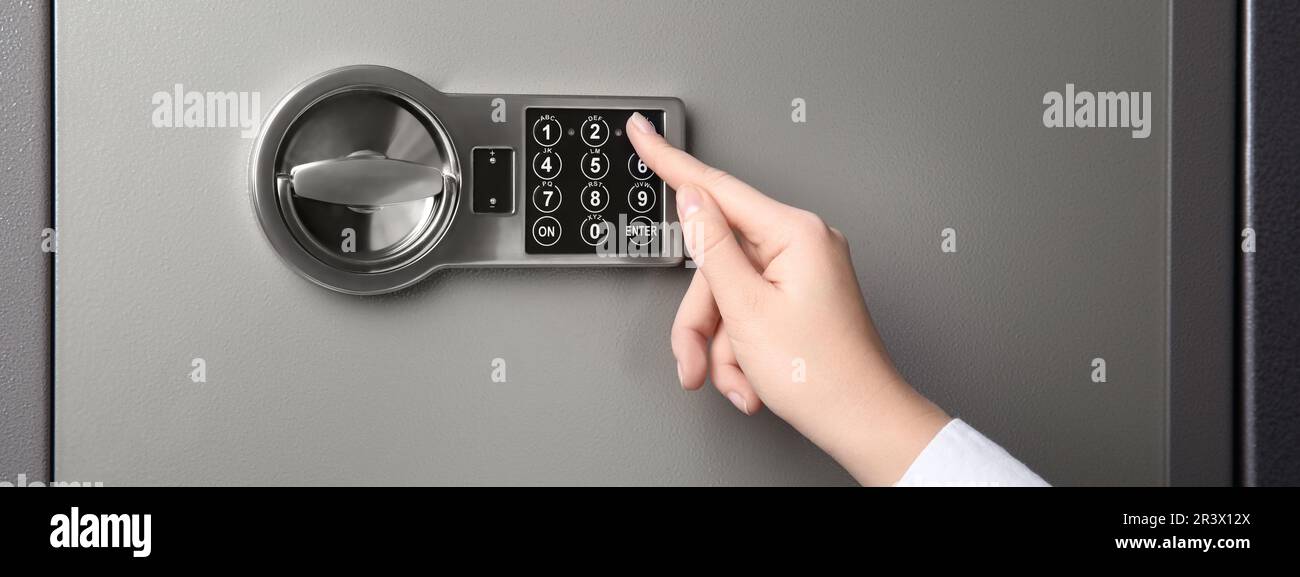 Woman opening steel safe with electronic lock, closeup. Banner design ...