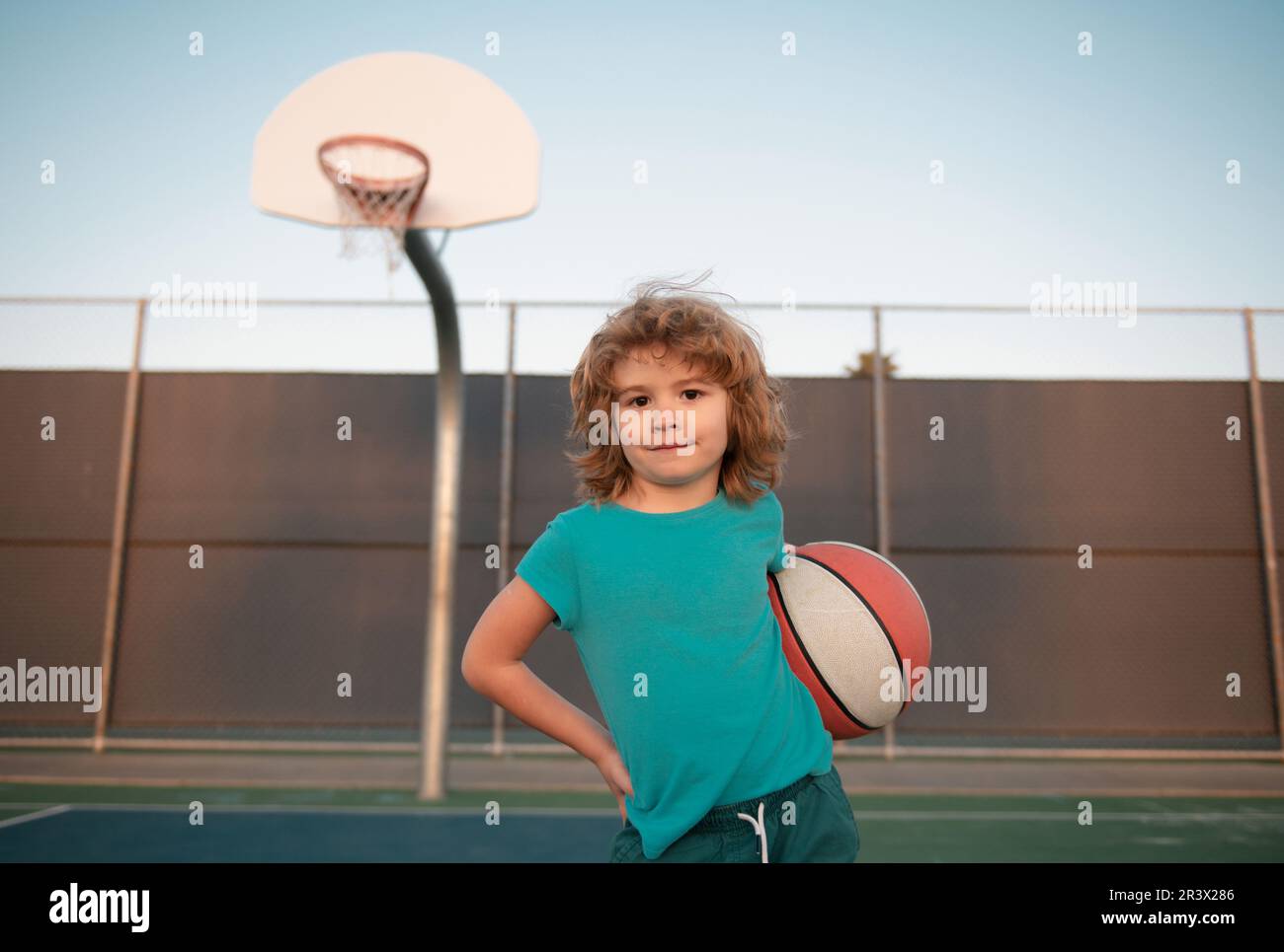Child boy preparing for basketball shooting. Young kid posing with a ...