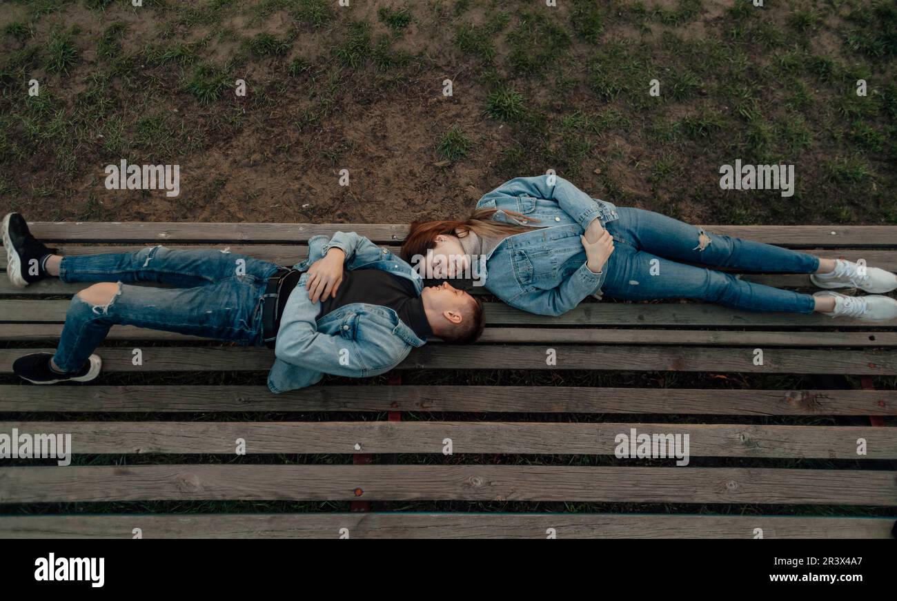 Young couple sleeping on bench hi-res stock photography and images - Alamy