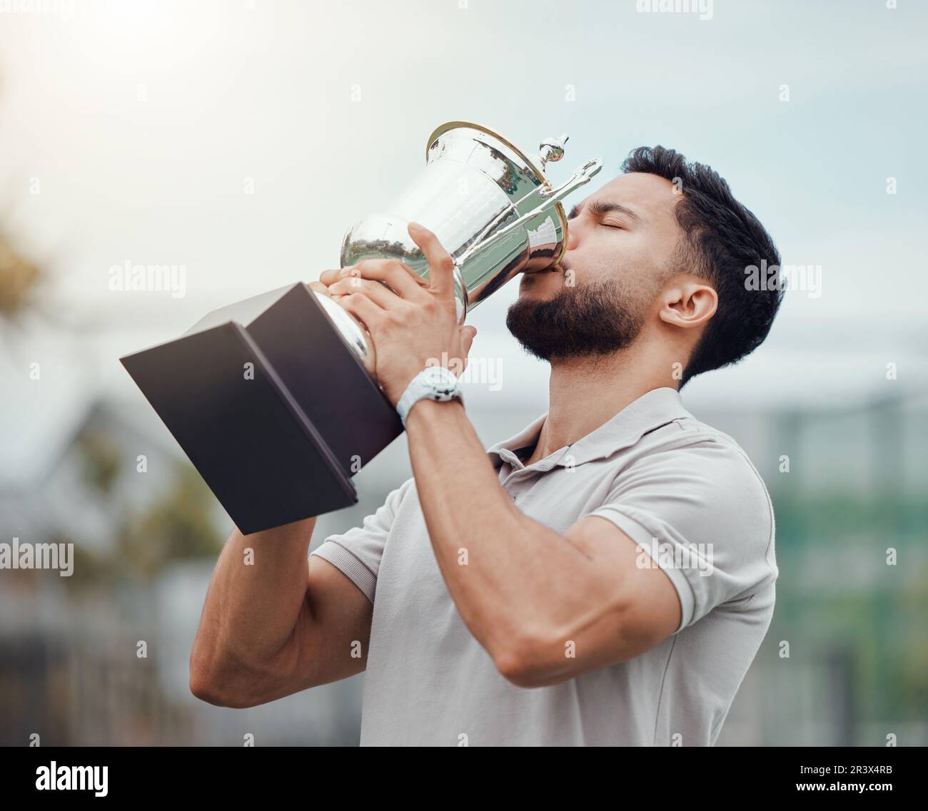 Man, tennis and kissing trophy in celebration for winning, success or ...