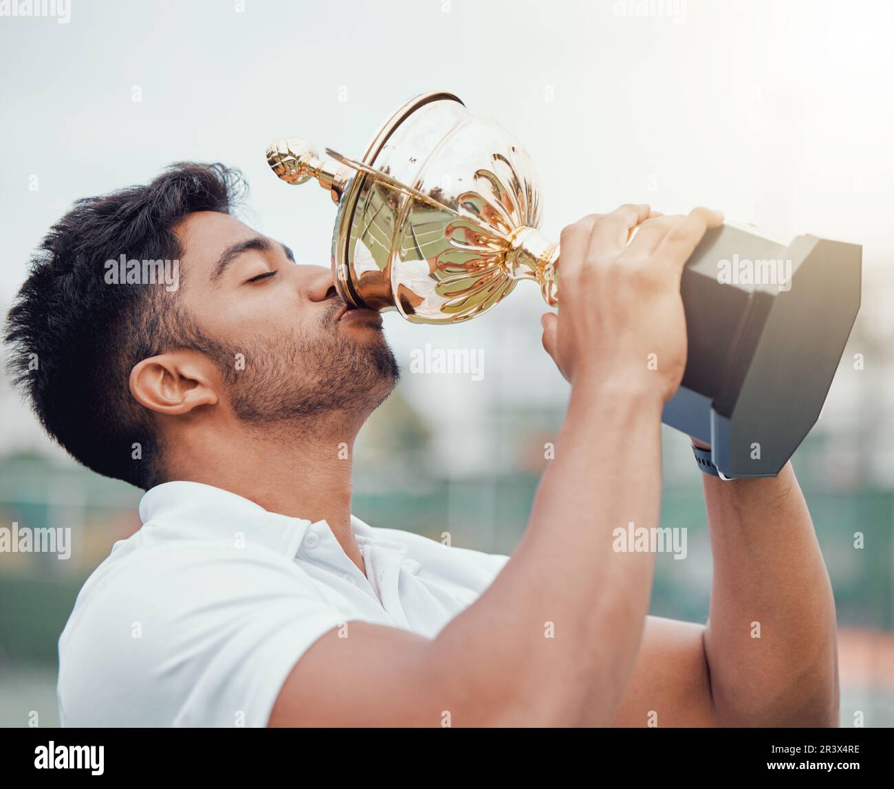 Man, tennis and kissing trophy for winning, success or achievement in ...