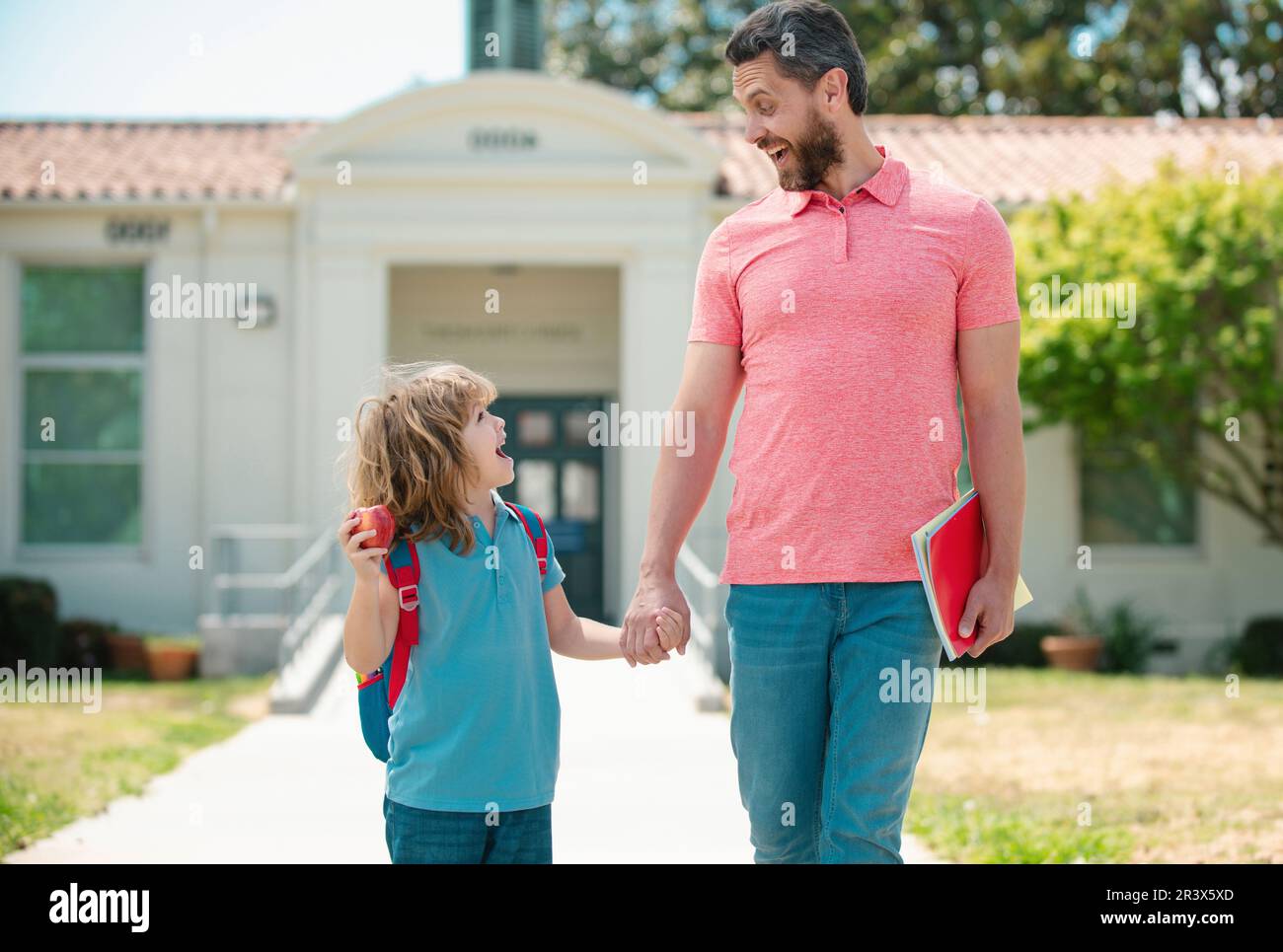 Father and son go to school, education and learning. Parent and pupil ...