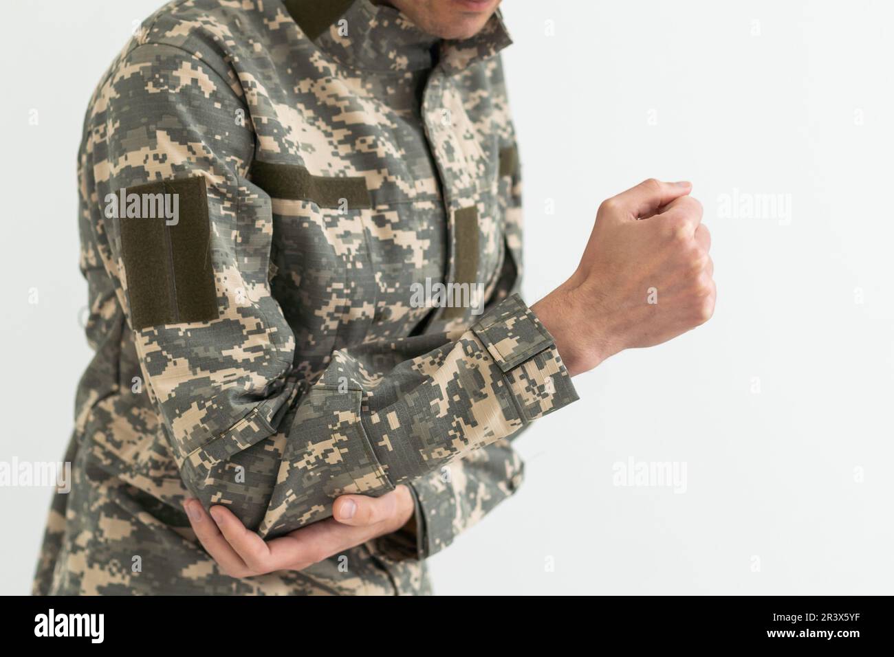 A military man has a pain in his arm Stock Photo - Alamy
