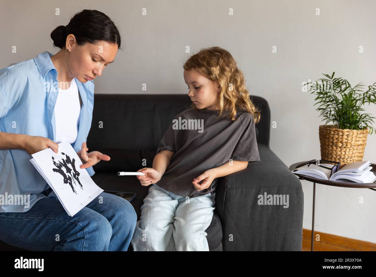 A child girl at a psychotherapist's appointment undergoes psychological ...
