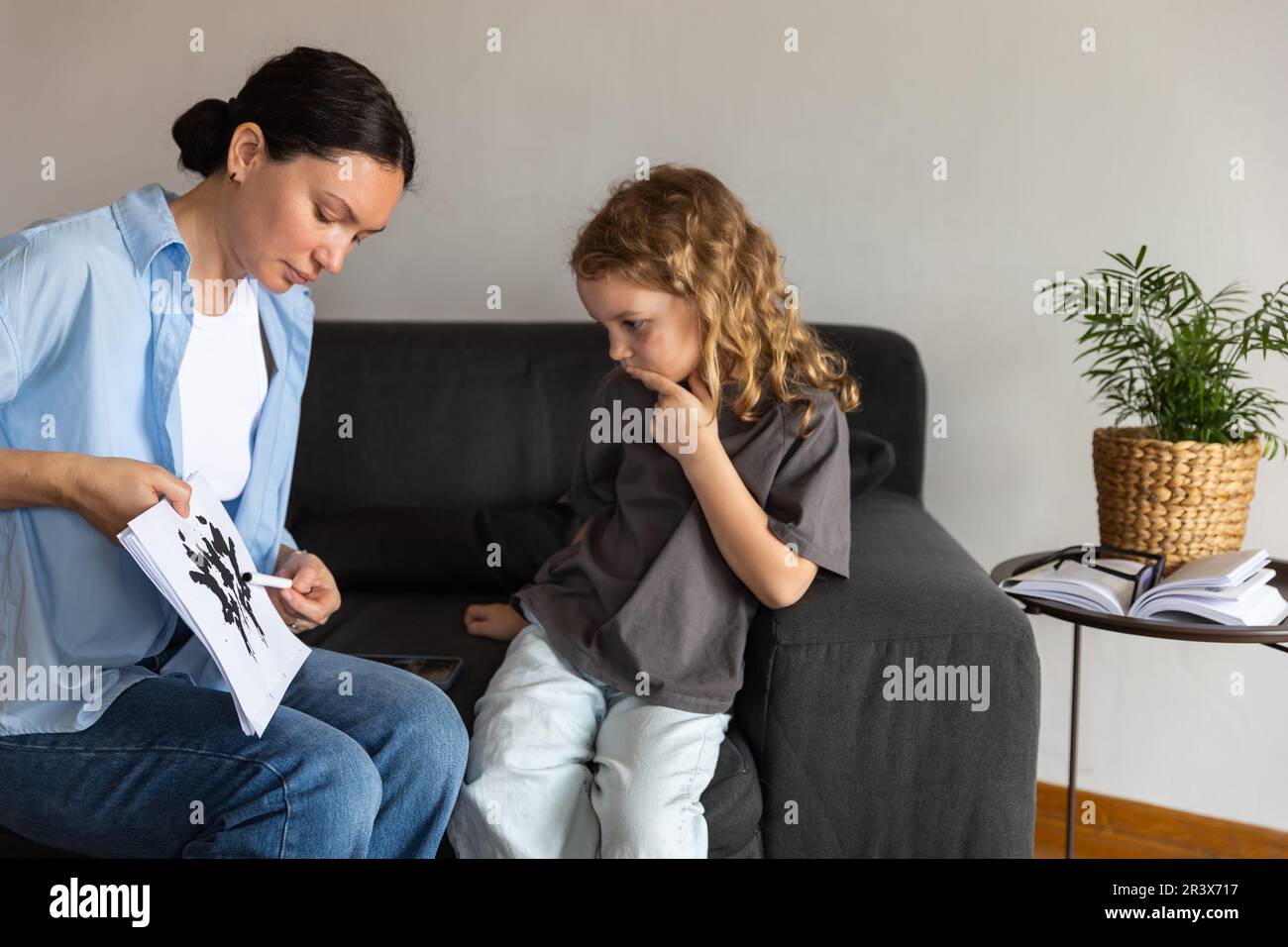 A child girl at a psychotherapist's appointment undergoes psychological ...