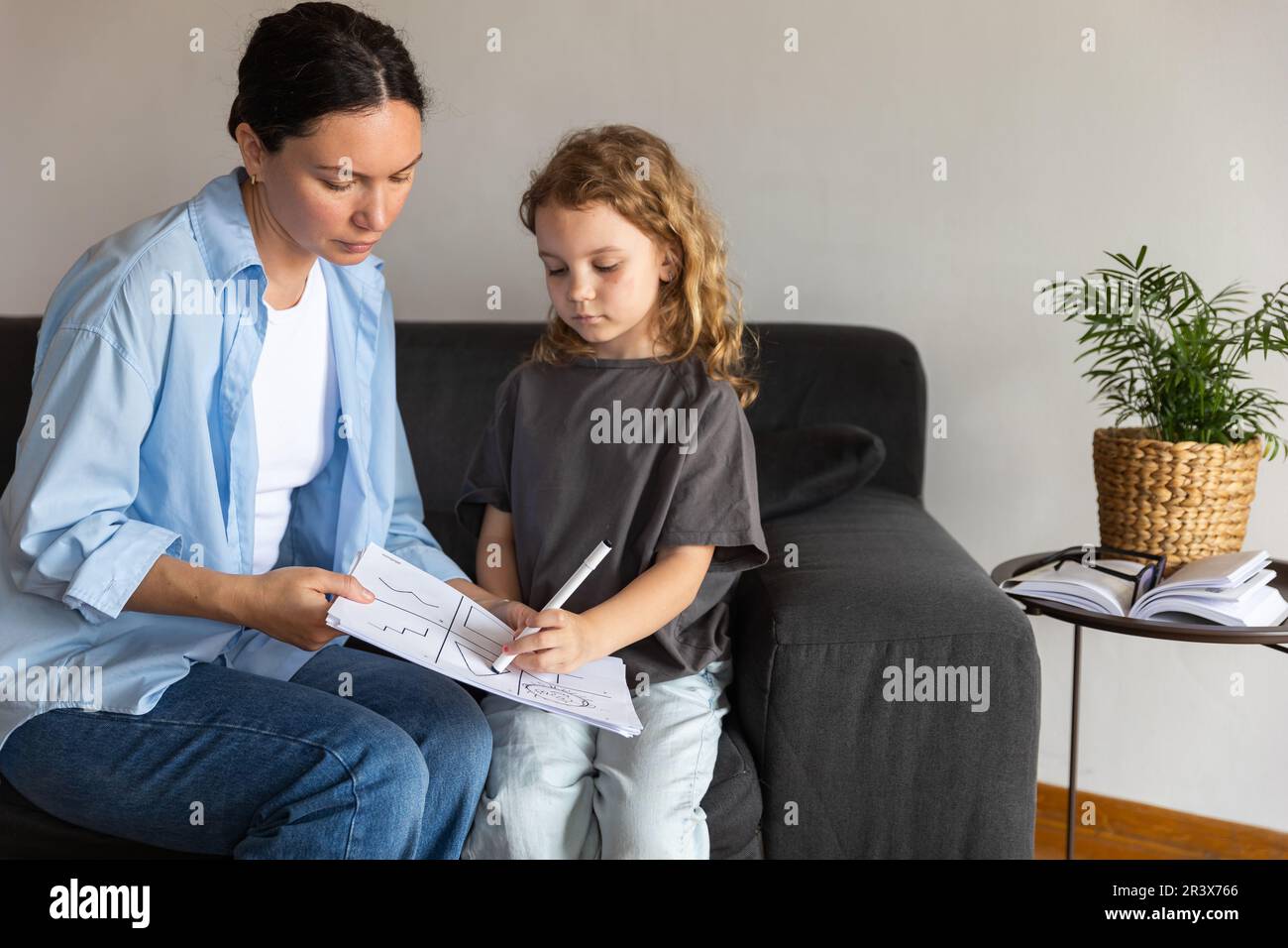 A child girl at a psychotherapist's appointment undergoes psychological ...