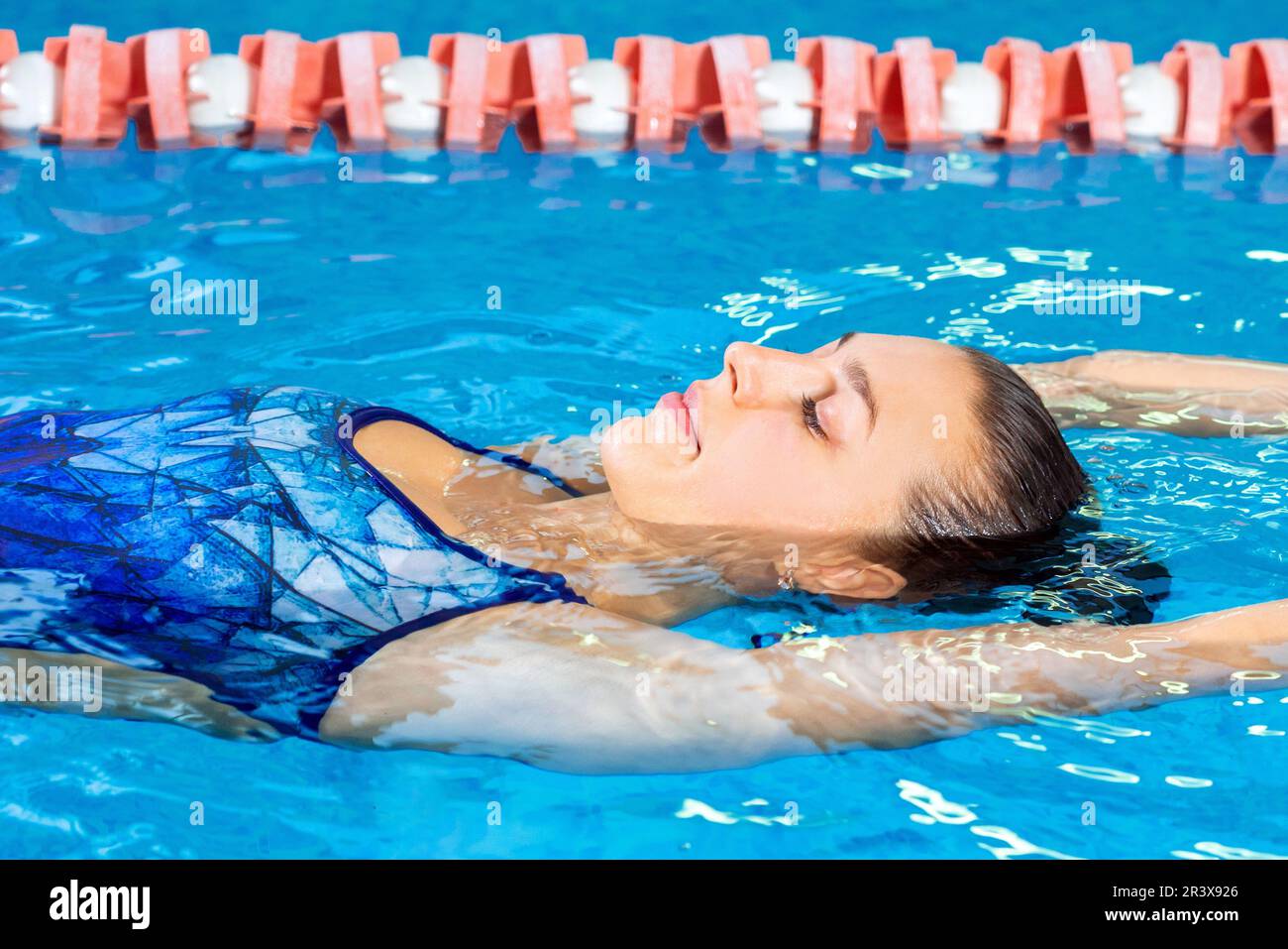 Young professional swimmer woman swimming in indoor pool Stock Photo ...