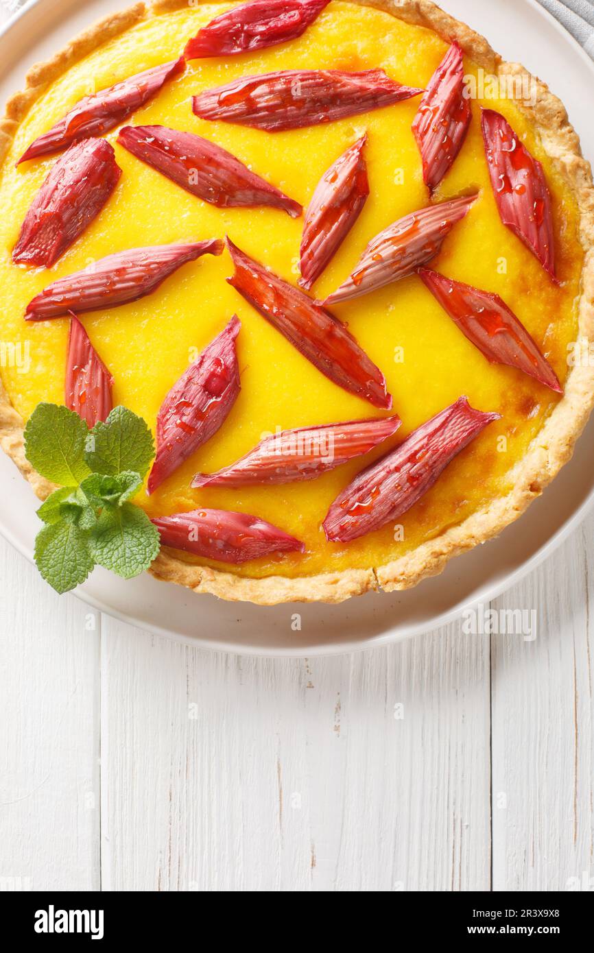 Crispy shortbread cake with custard and rhubarb close-up in a plate on ...