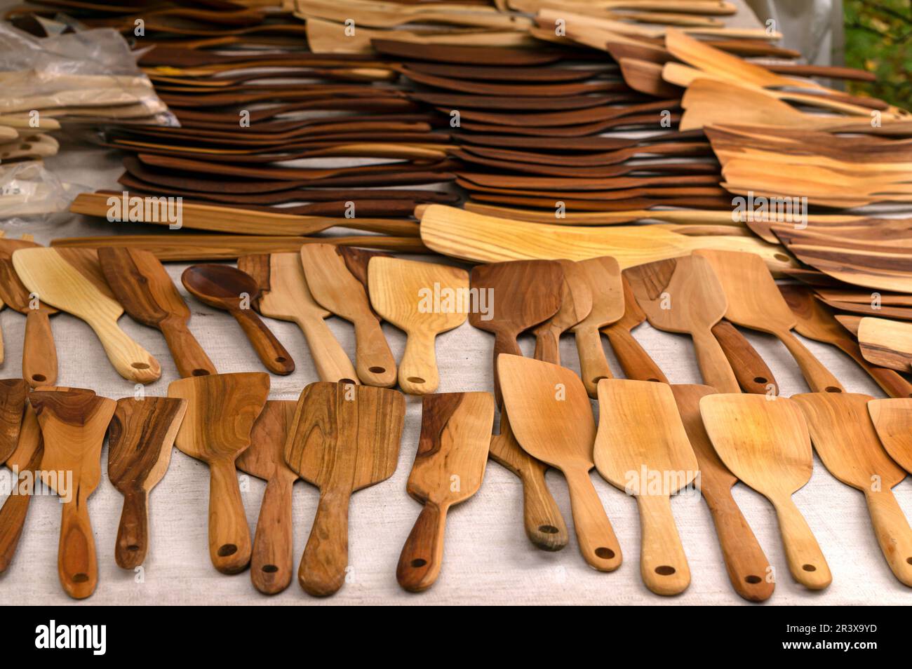 Carved wooden handicrafts, kitchen utensils on the counter of the craft ...