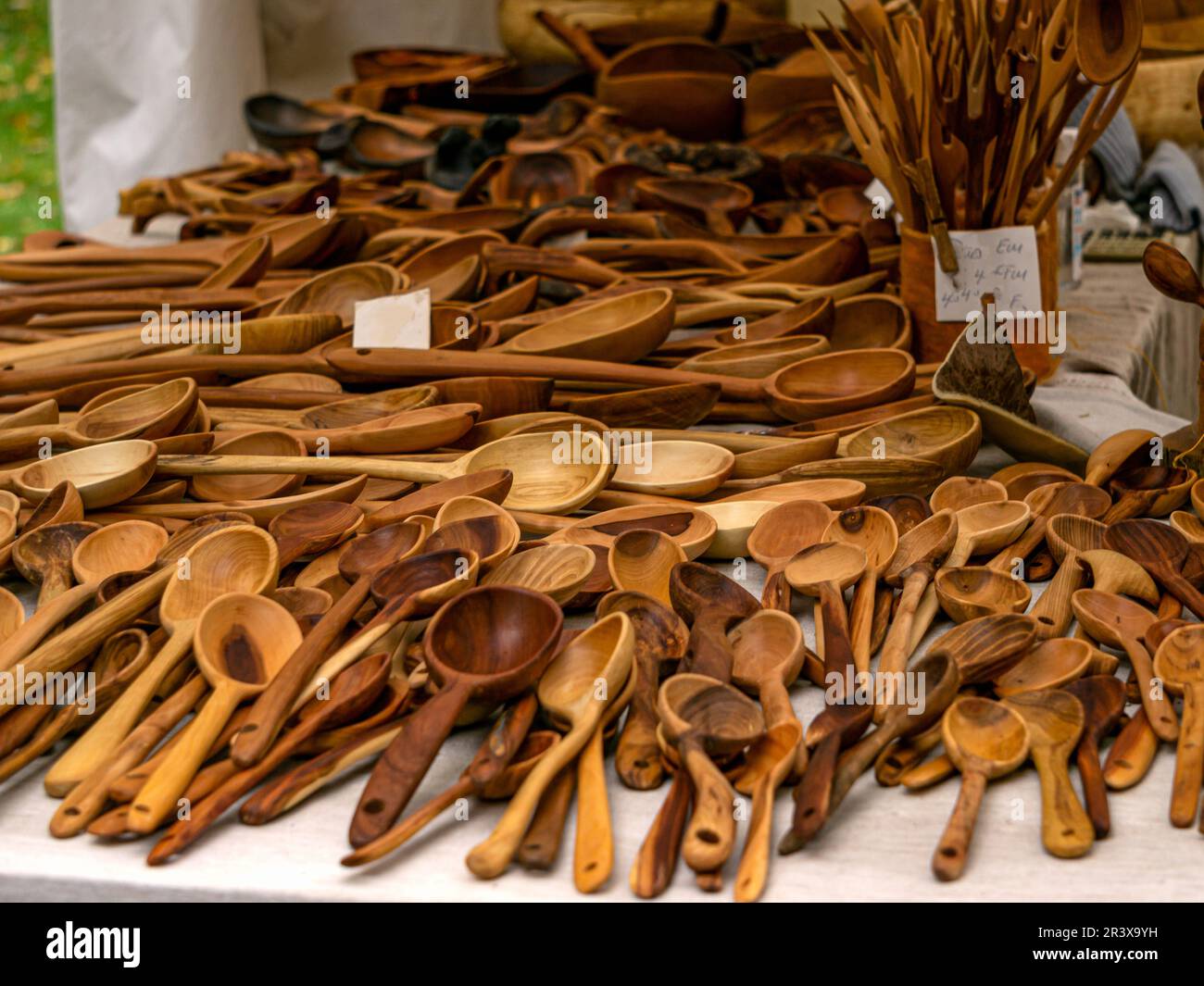 Carved wooden handicrafts, kitchen utensils on the counter of the craft ...