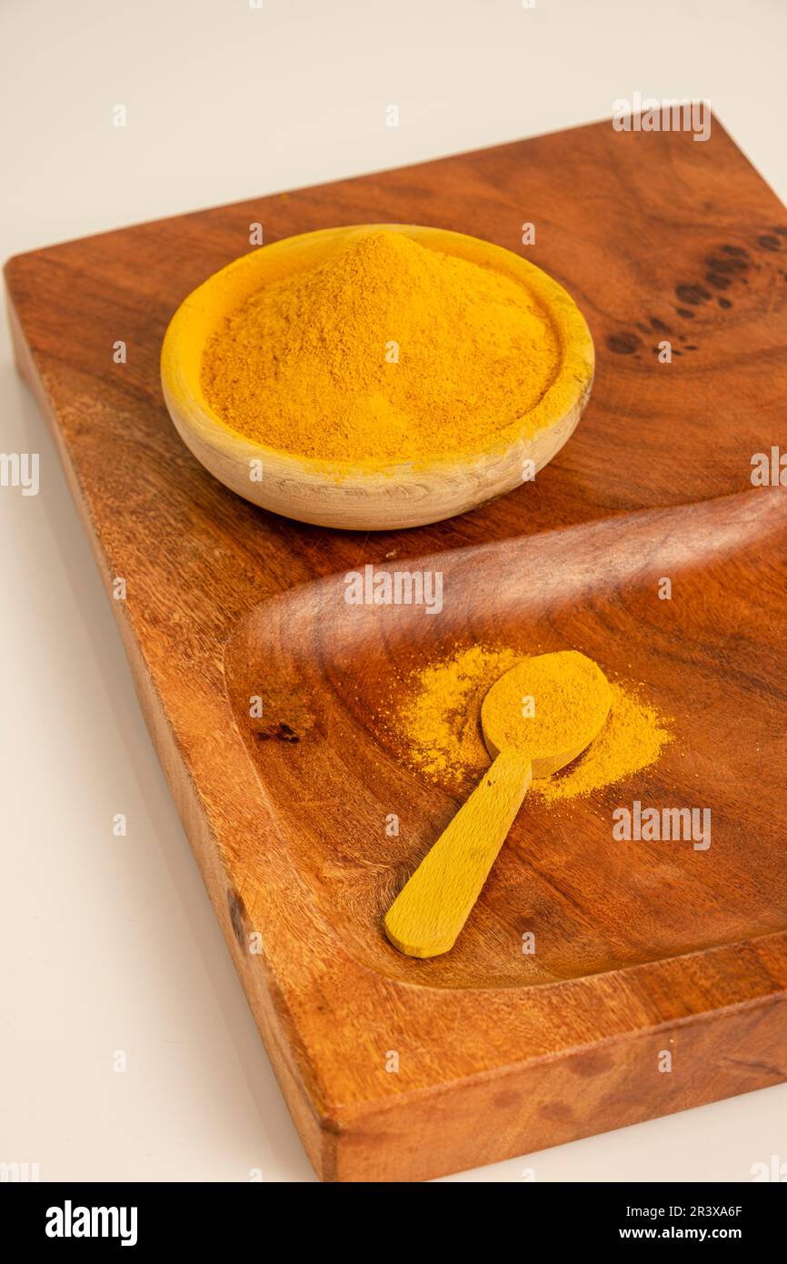 ground turmeric on a wood Stock Photo - Alamy