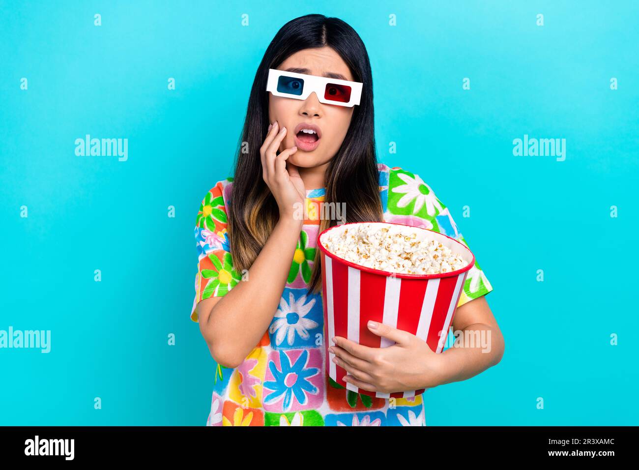 Photo of scared shocked lady wear flower print t-shirt eating pop corn ...