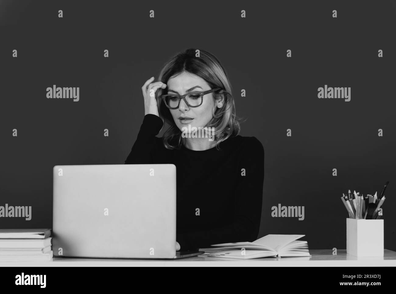 Pretty young high school or college teacher on the chalkboard. Young ...