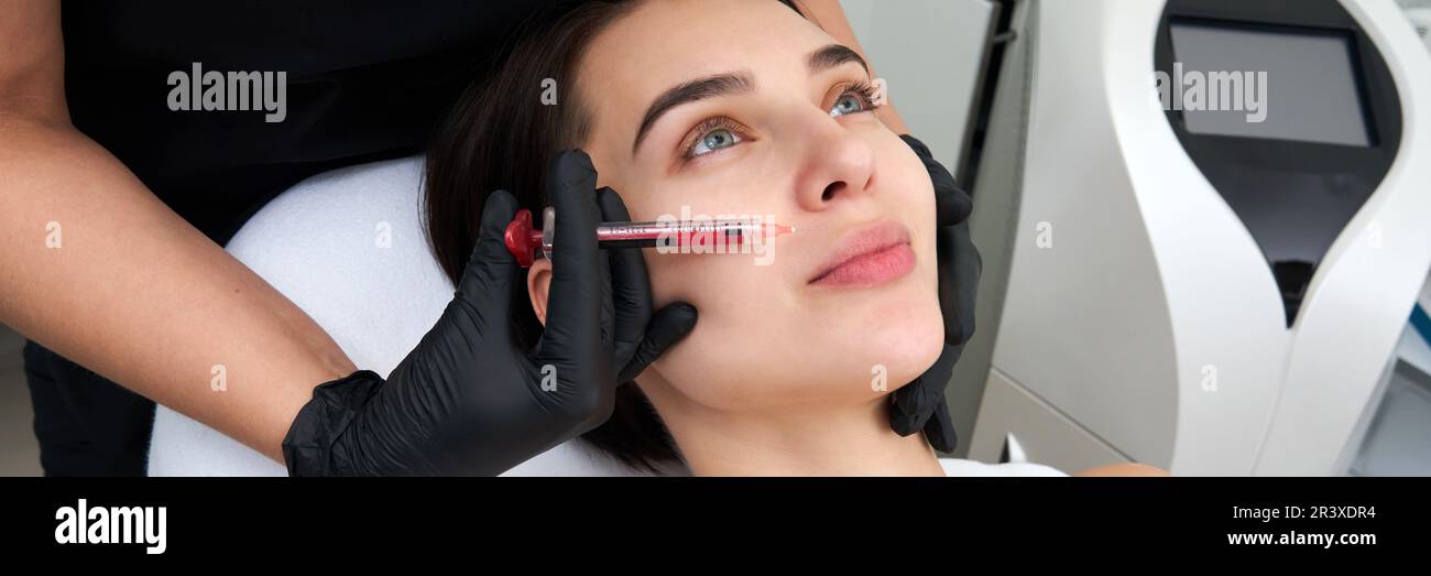 Beautiful woman gets an injection in her lips Stock Photo - Alamy