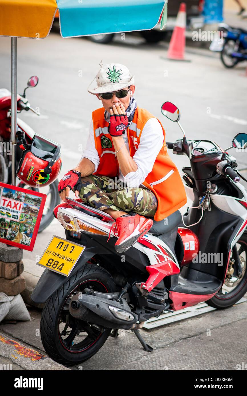 A very cool looking Thai motorcycle rider who works as a taxi service ...