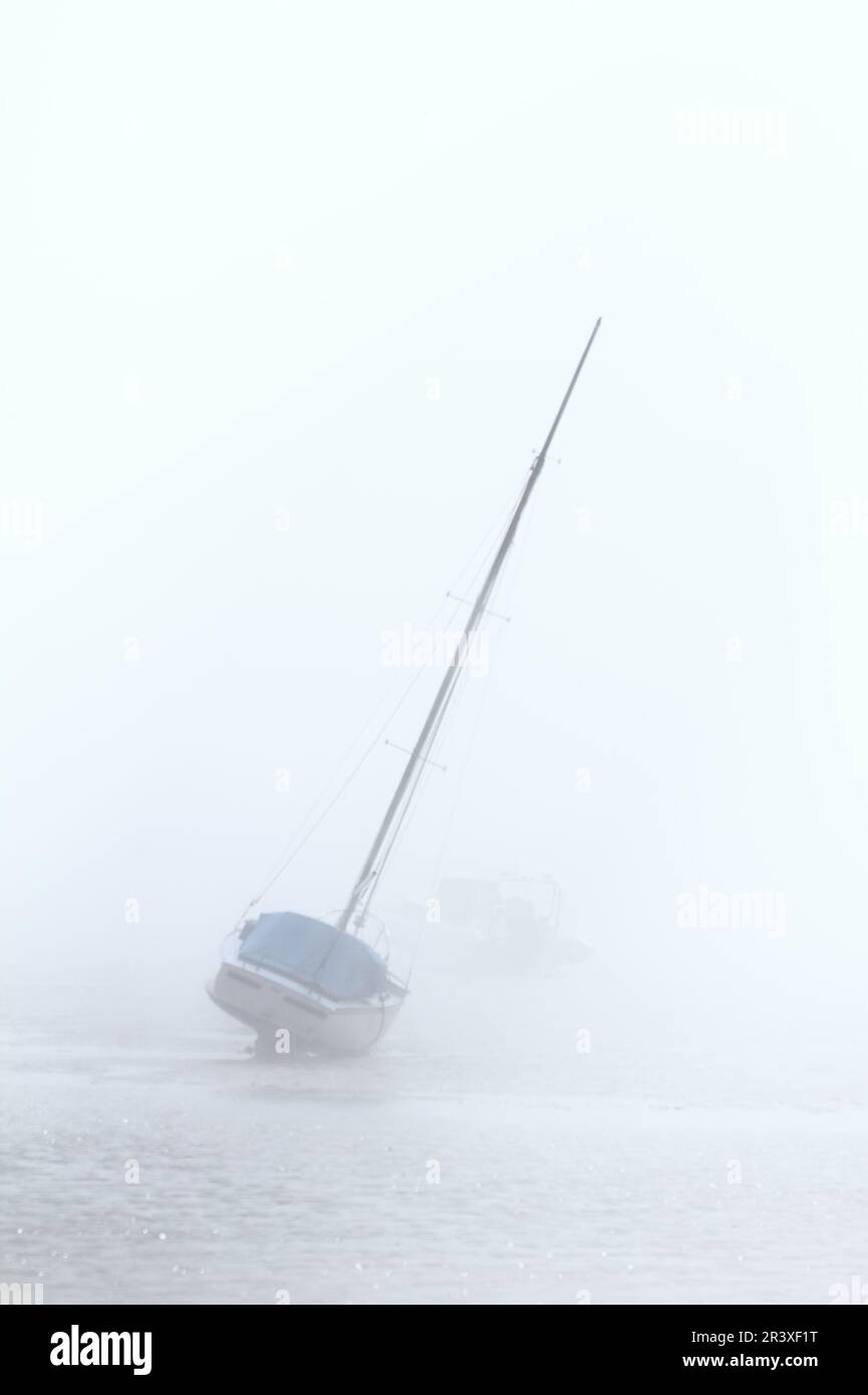 Sailing Boat Yacht At Low Tide In Sea Mist, Christchurch Harbour, UK ...