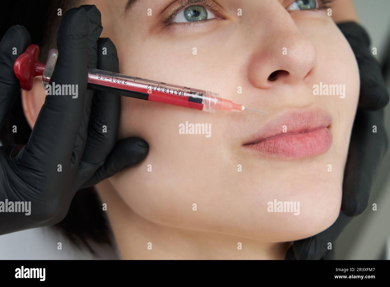 Beautiful woman gets an injection in her lips Stock Photo - Alamy