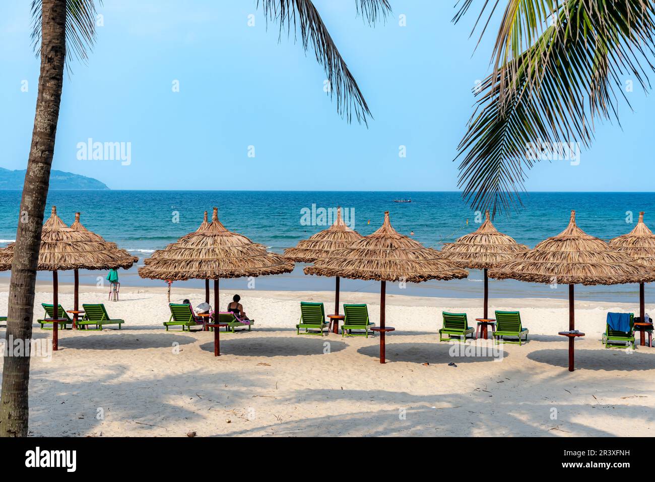 Umbrellas and loungers lie on the white sand beach for tourists at the ...