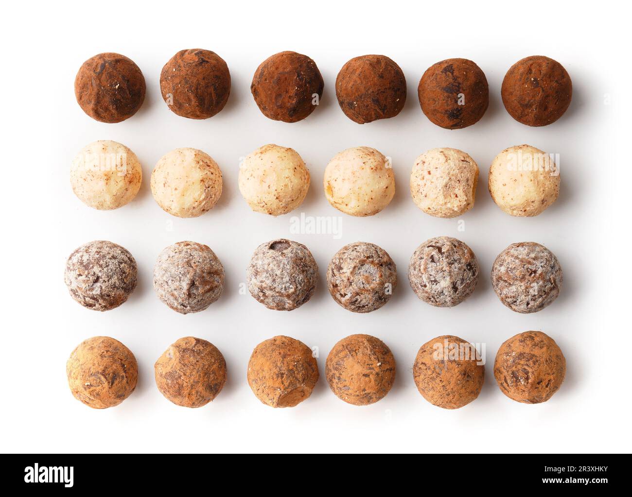 Various types of chocolate truffles on a white background top view ...