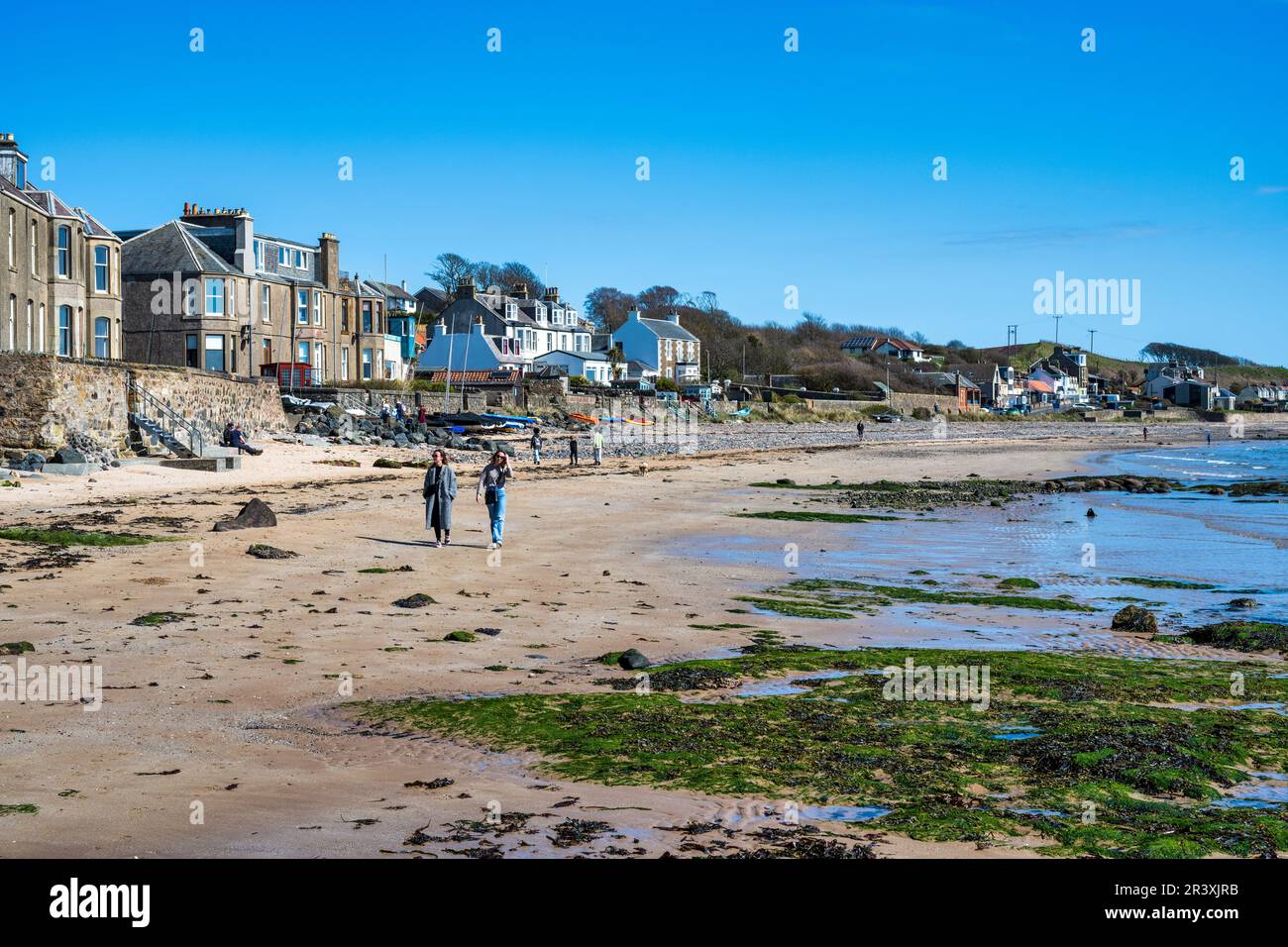 View looking north along sandy beach at Scottish coastal town of Lower ...