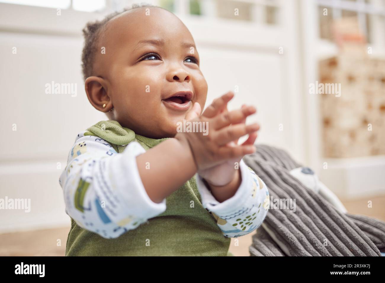 Happy, baby and black child clapping in home, having fun or enjoying ...
