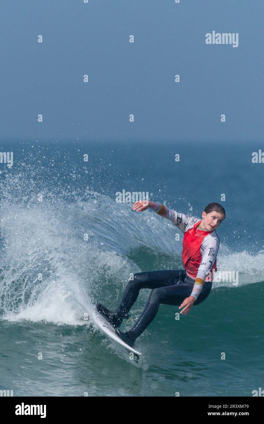 A female surfer competing in a surfing competition at Fistral in ...