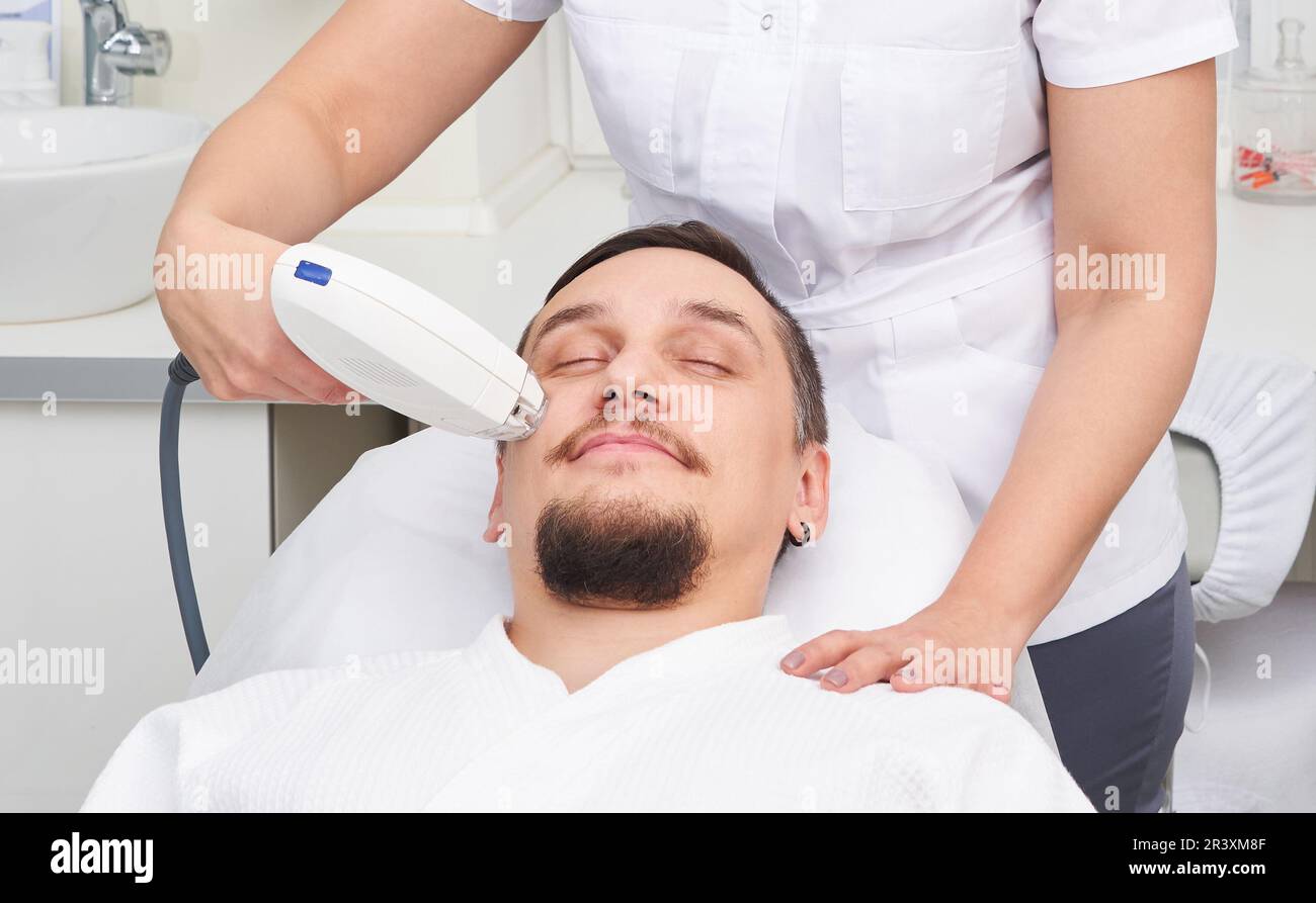 Man Having Laser Treatment At Beauty Clinic Stock Photo - Alamy