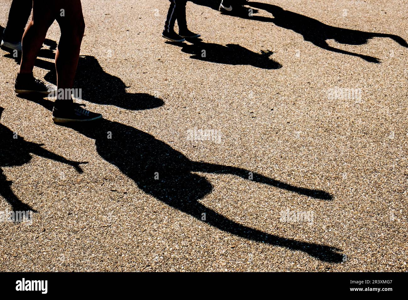 Shadows cast by people dancing on the Killacourt in Newquay in Cornwall ...