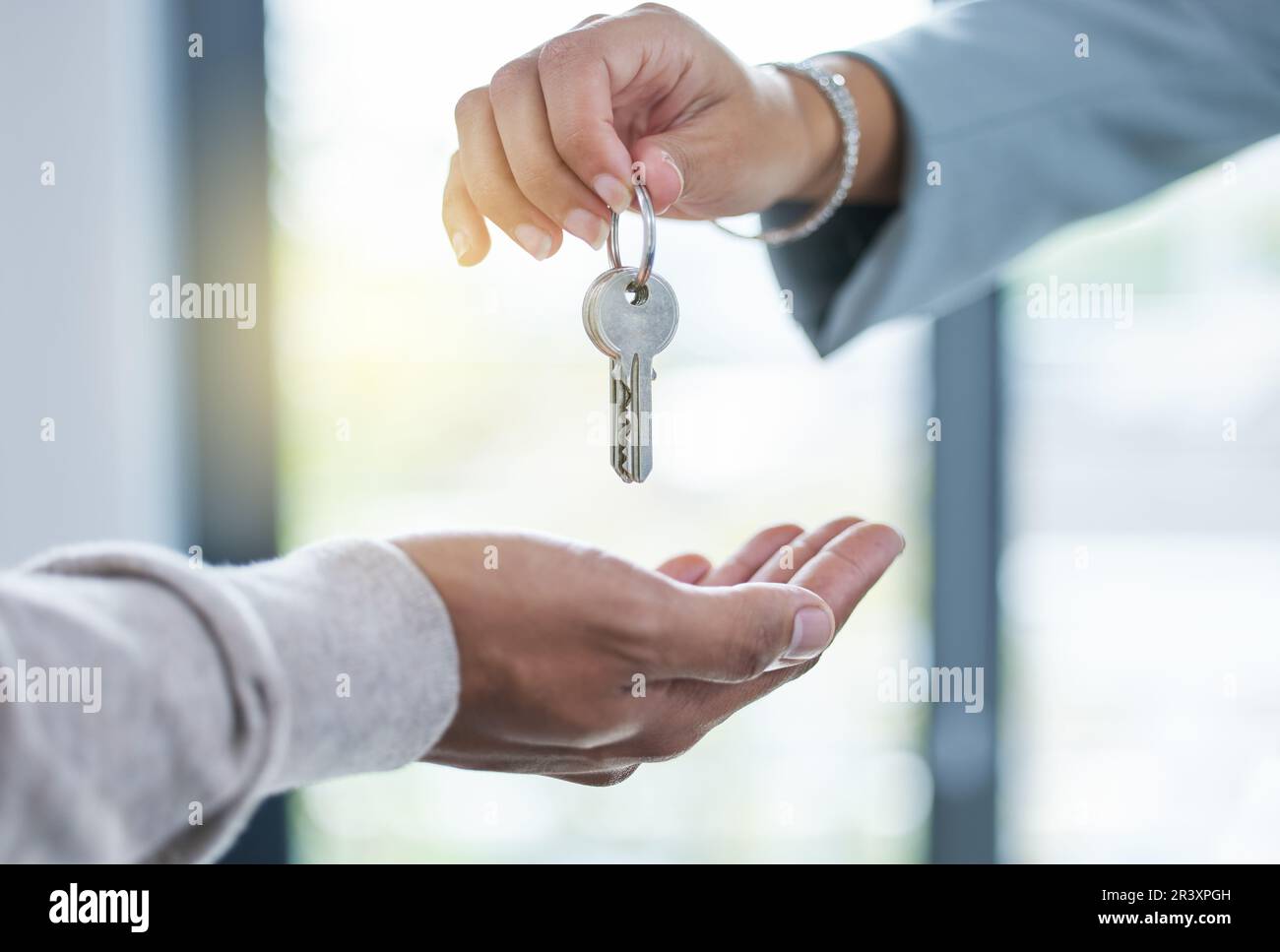 Keys, hands and sale of property, house or real estate investment with ...