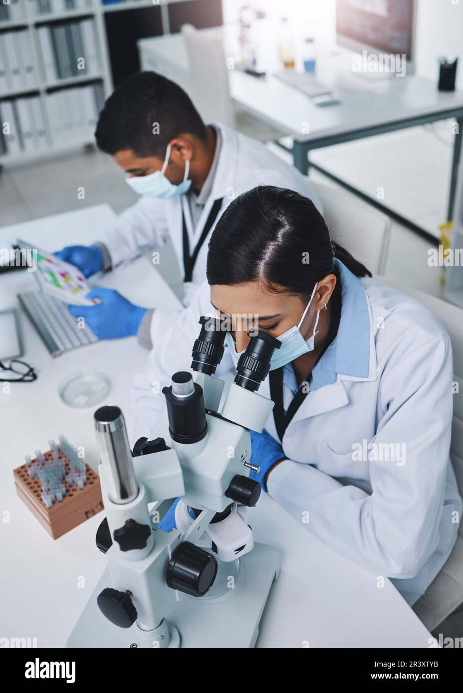 Science, laboratory and man and woman with microscope for research ...