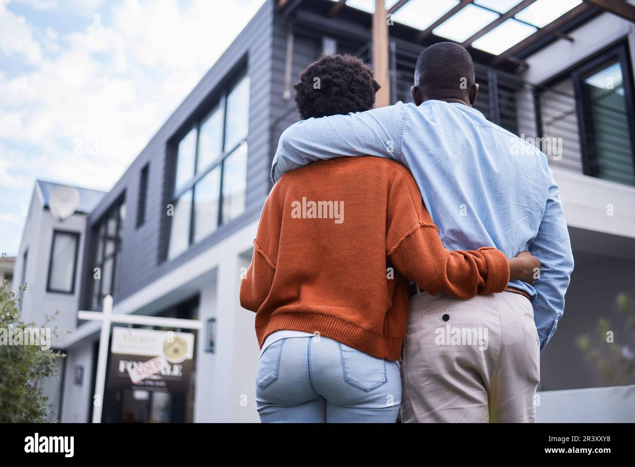 Love, hugging and back of couple by their new home, property or real ...