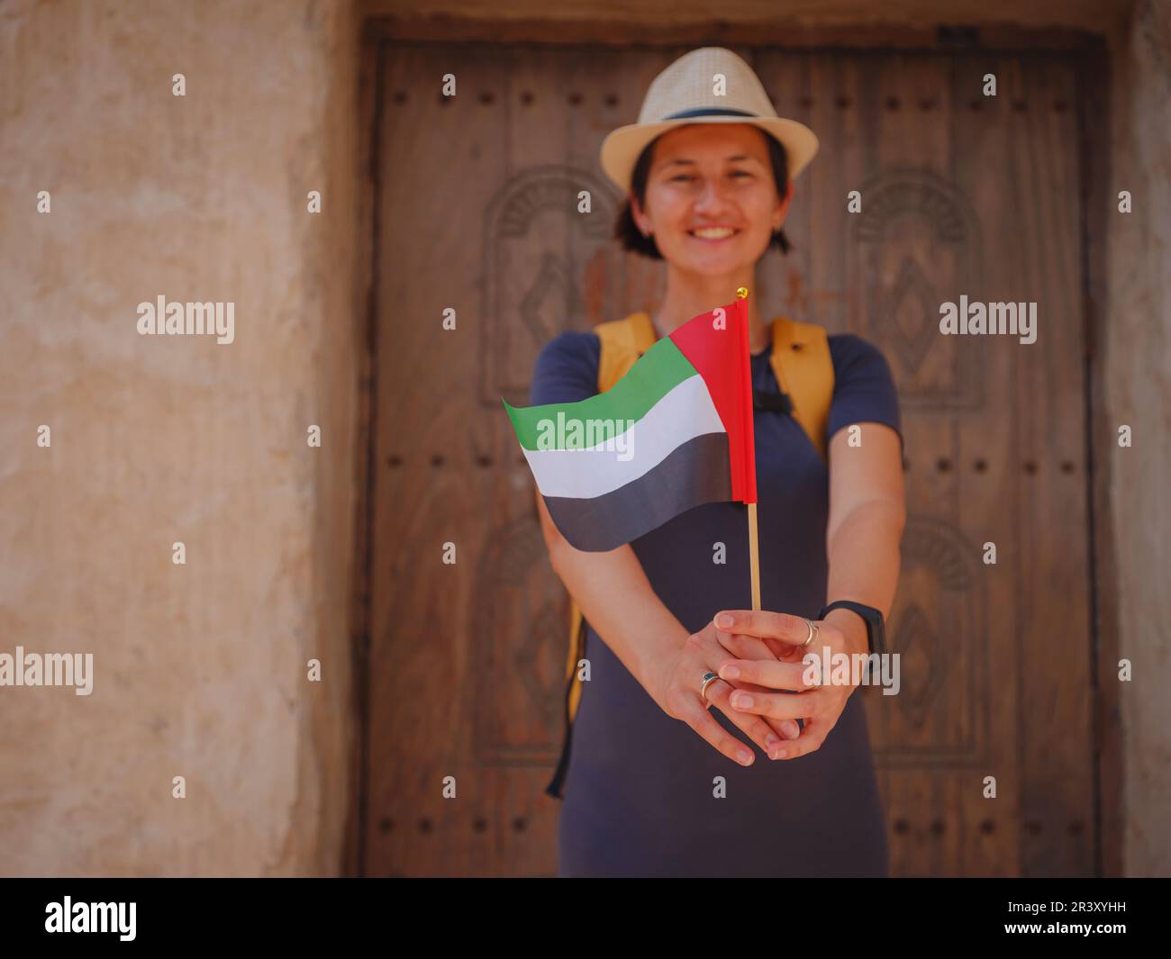tourist trip to old Dubai, UAE. Asian Woman tourist holding UAE flag in ...