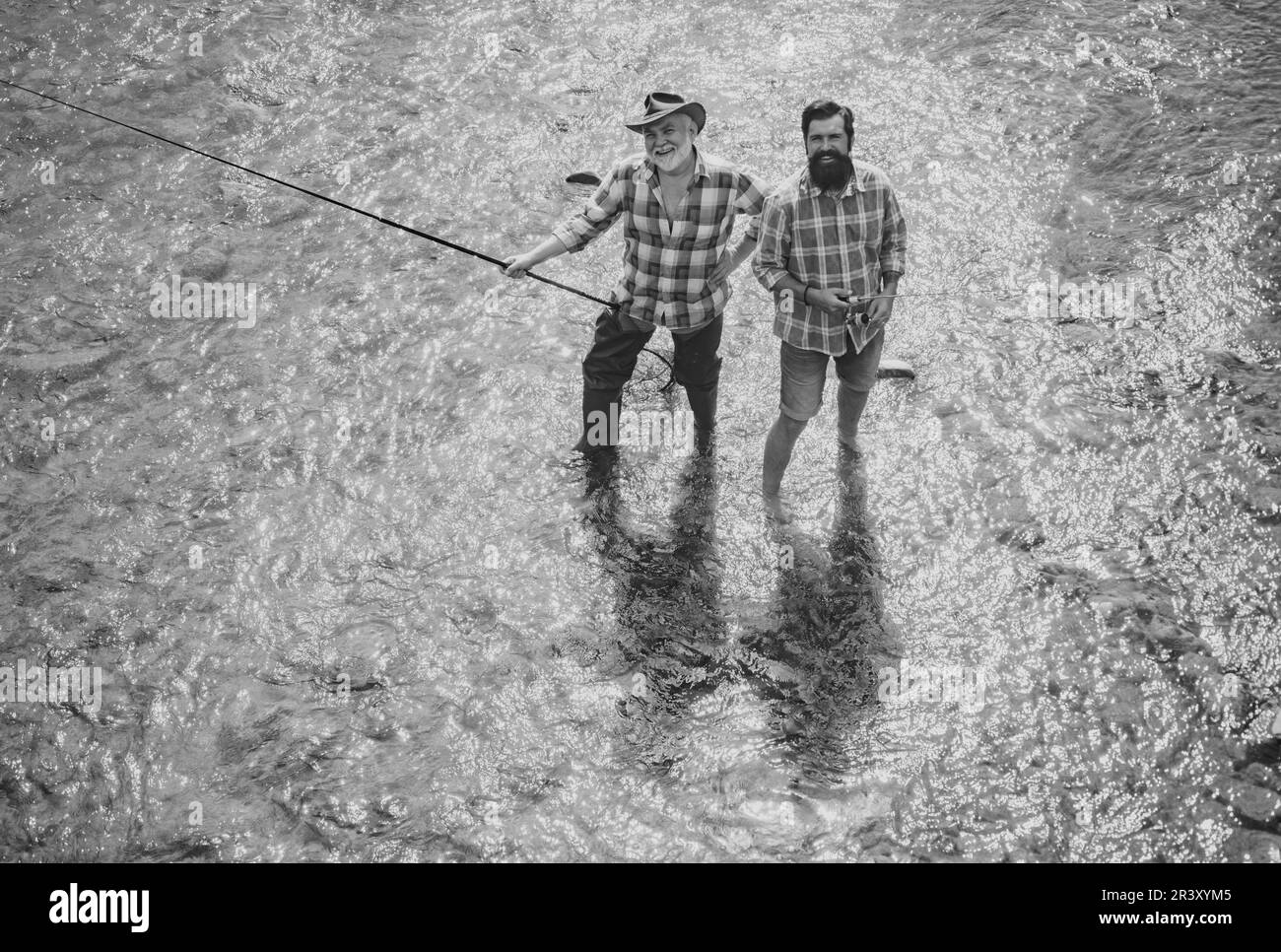 Portrait of cheerful senior man fishing. Grandfather and son fishermans ...