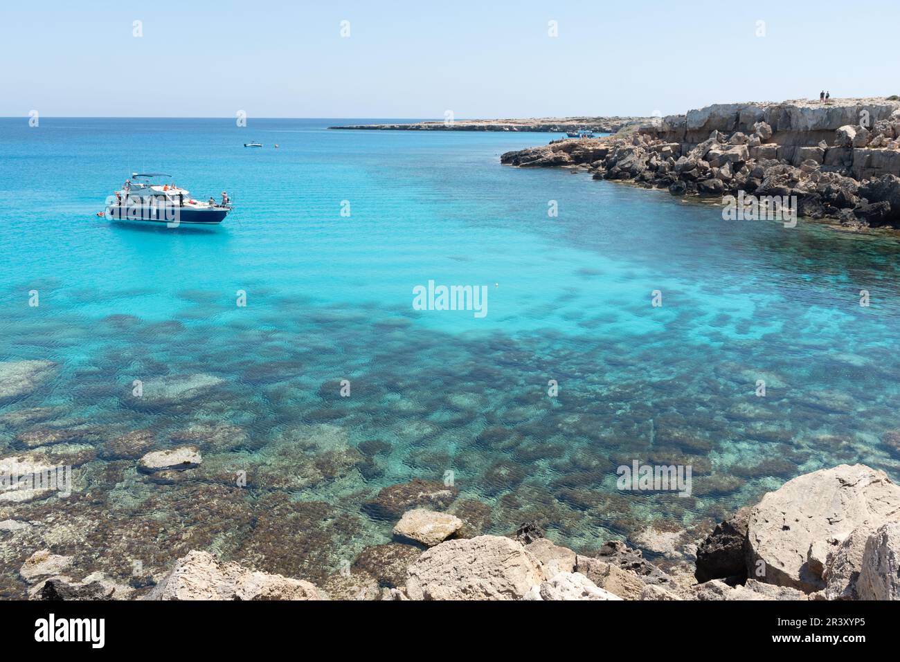 Tourist yacht sailing in the sea with tourists enjoying summer holidays ...
