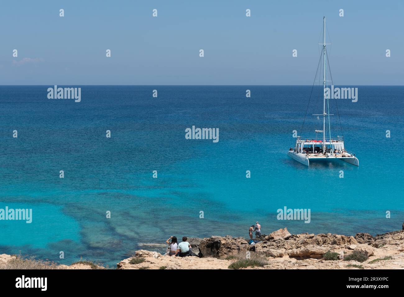 Tourist yacht sailing in the sea with tourists enjoying summer holidays ...