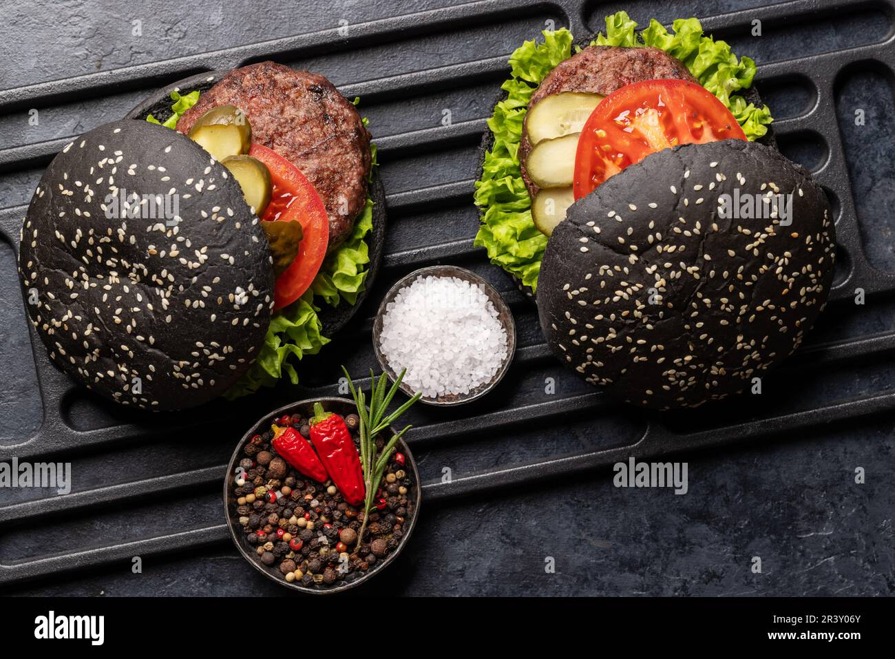 Homemade beef burgers with black buns. Flat lay Stock Photo - Alamy