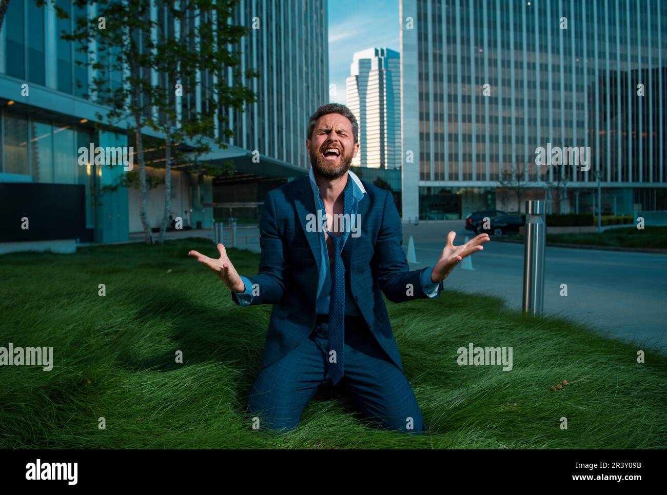Business man crying in depression sitting on ground street suffering ...