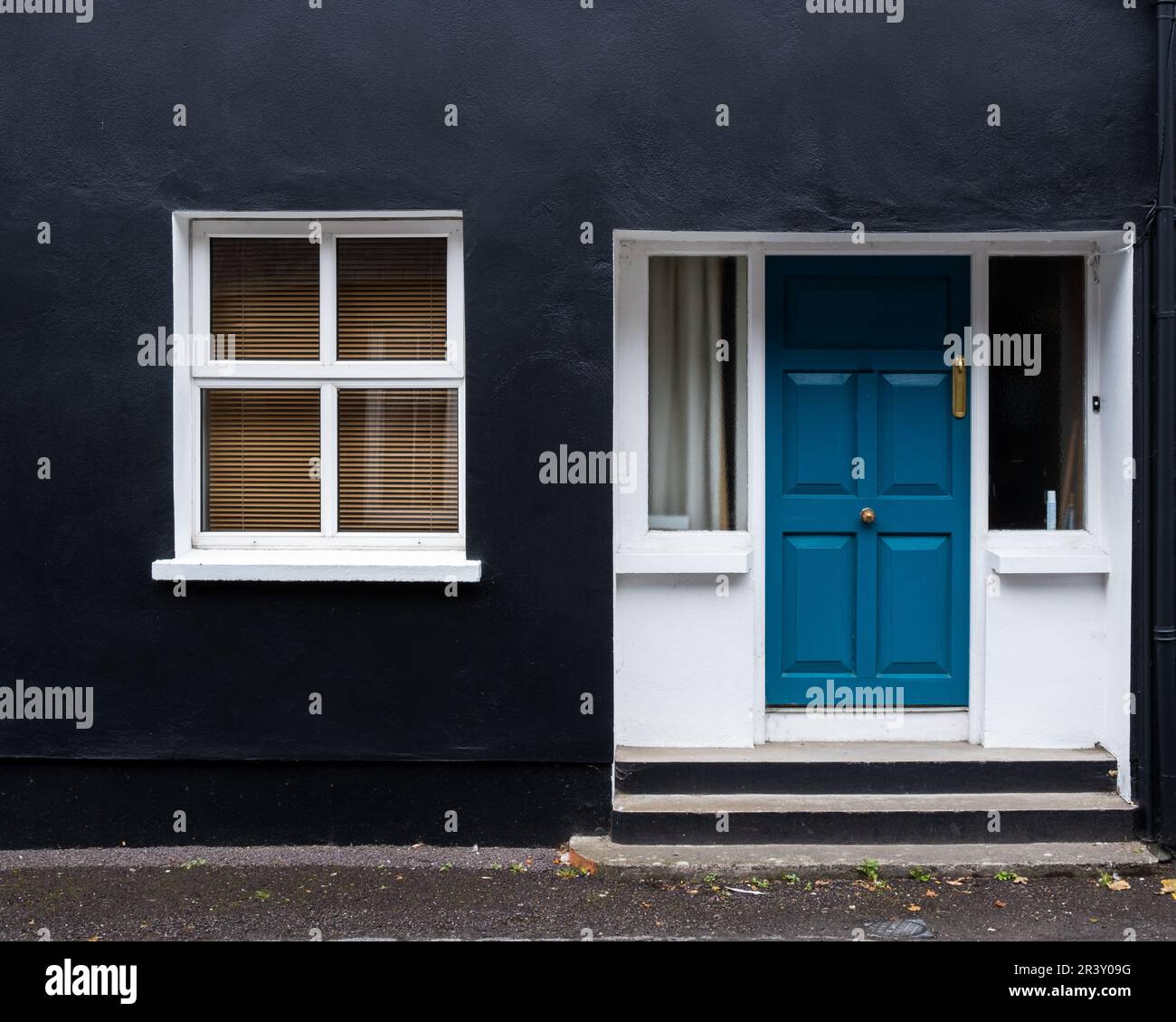 Traditional colourful house facade with closed window and door in ...