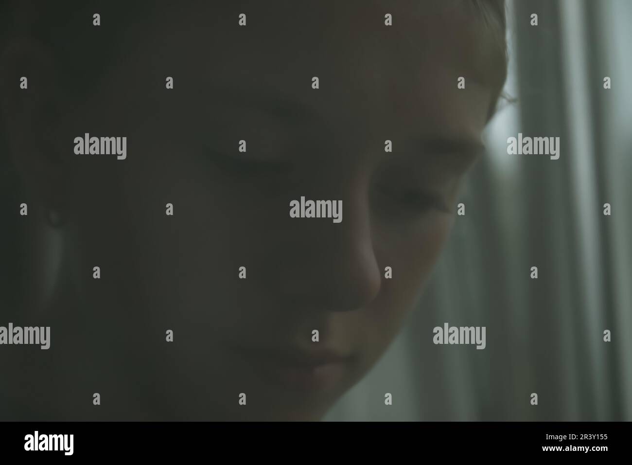 Defocus sad depressed young teenage girl on dark background. School ...