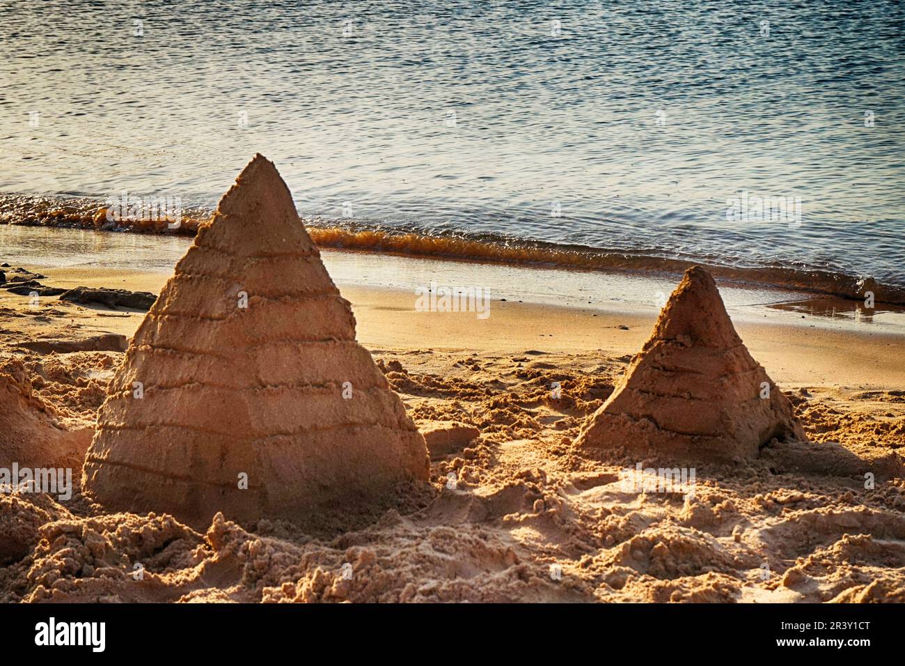 pyramid from the sand on the beach Stock Photo - Alamy