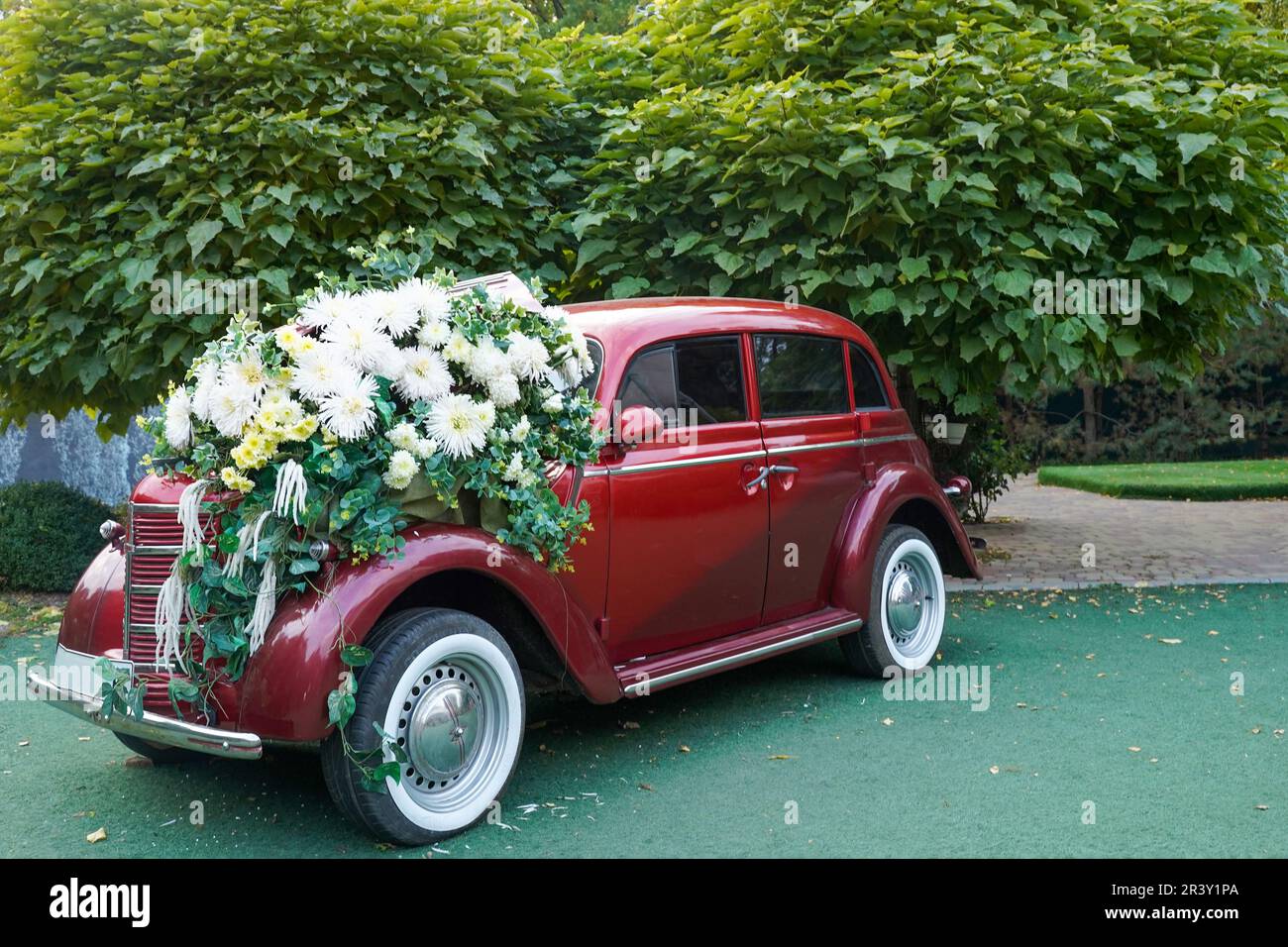 Retro car with flowers on the hood, original garden decor Stock Photo ...