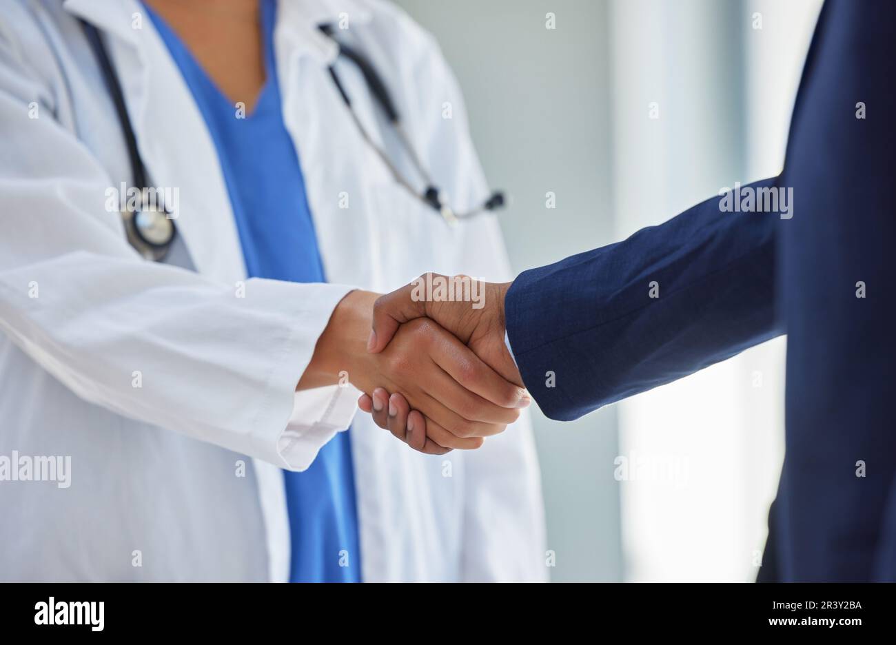 Business handshake and doctor partnership in a hospital with thank you ...