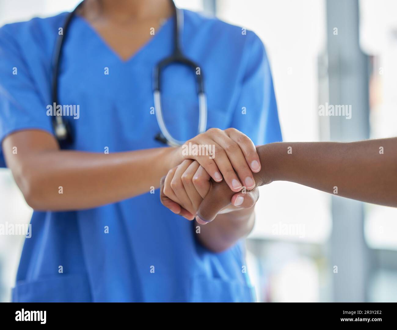 Nurse, holding hands and patient with support, help and grief consulting after cancer news ...