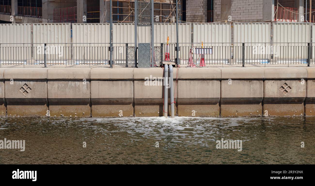 Dirty sewage from pipe, environmental pollution. Dubai city, bussines ...