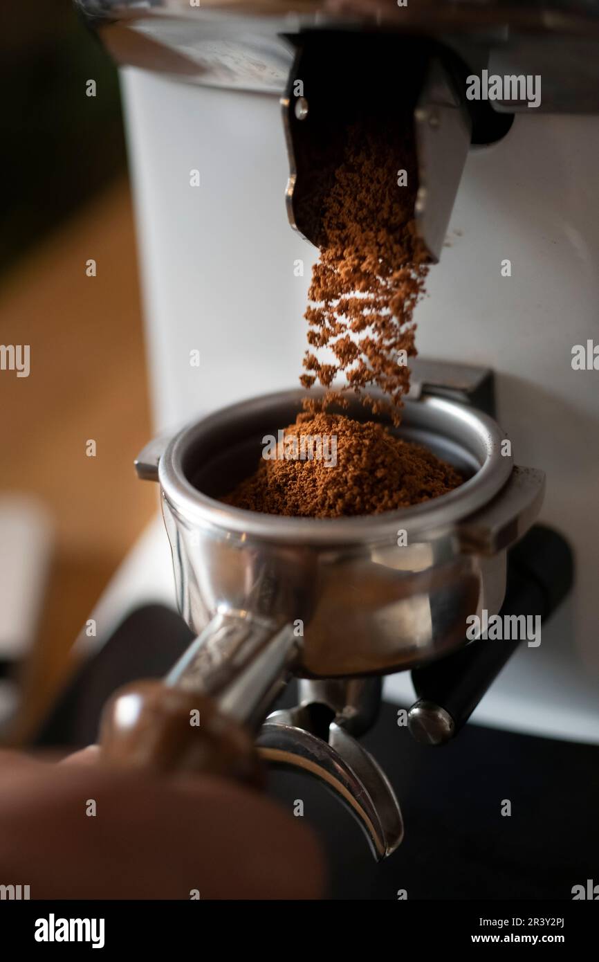 Coffee prep, the home Barista making Espresso using a Grinding Machine ...