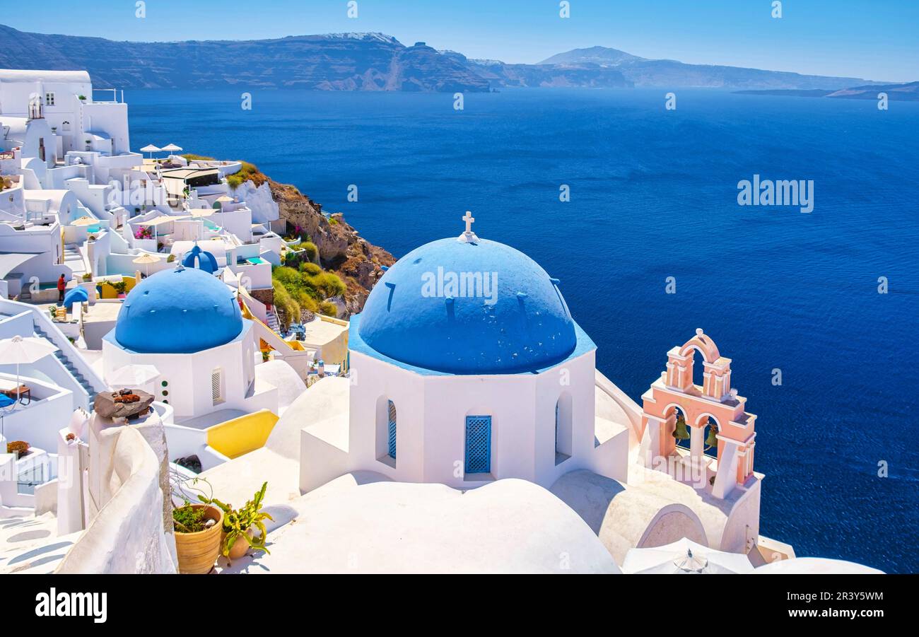 White churches an blue domes by the ocean of Oia Santorini Greece ...